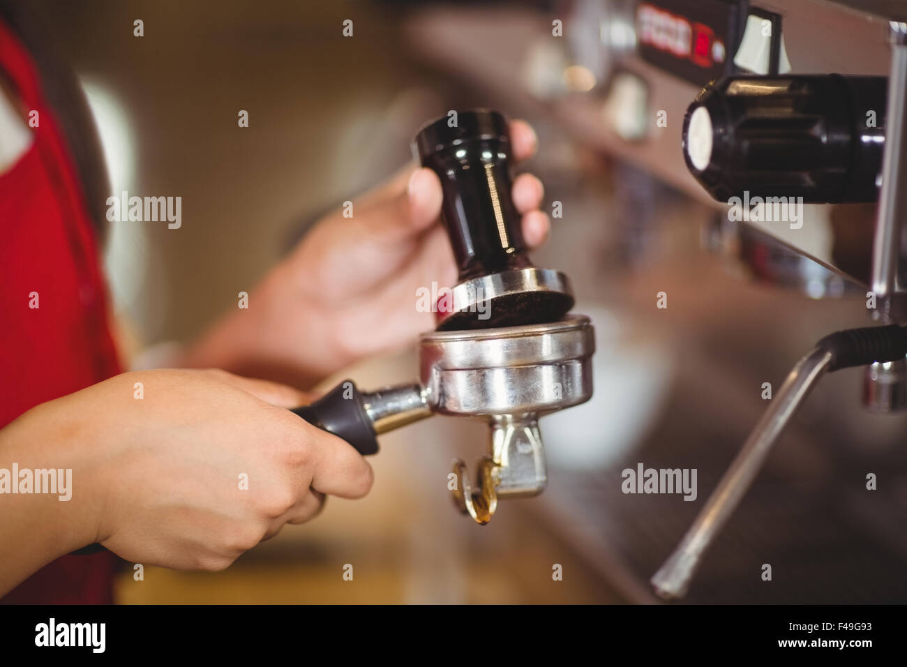 Close up of a barista pressing coffee Stock Photo - Alamy