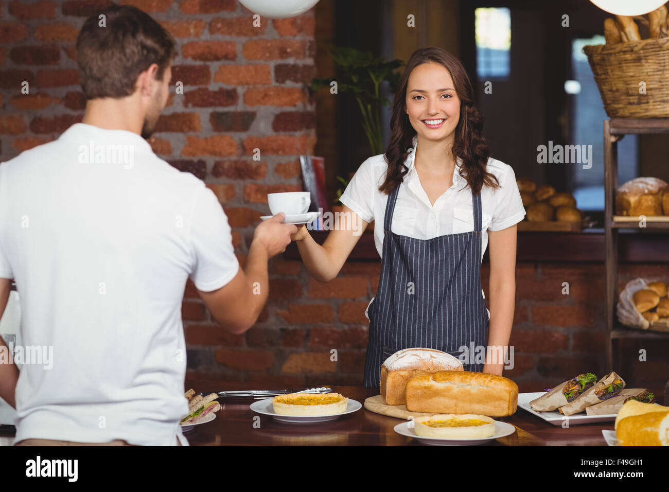 Pretty smiling barista serving hi-res stock photography and images - Alamy