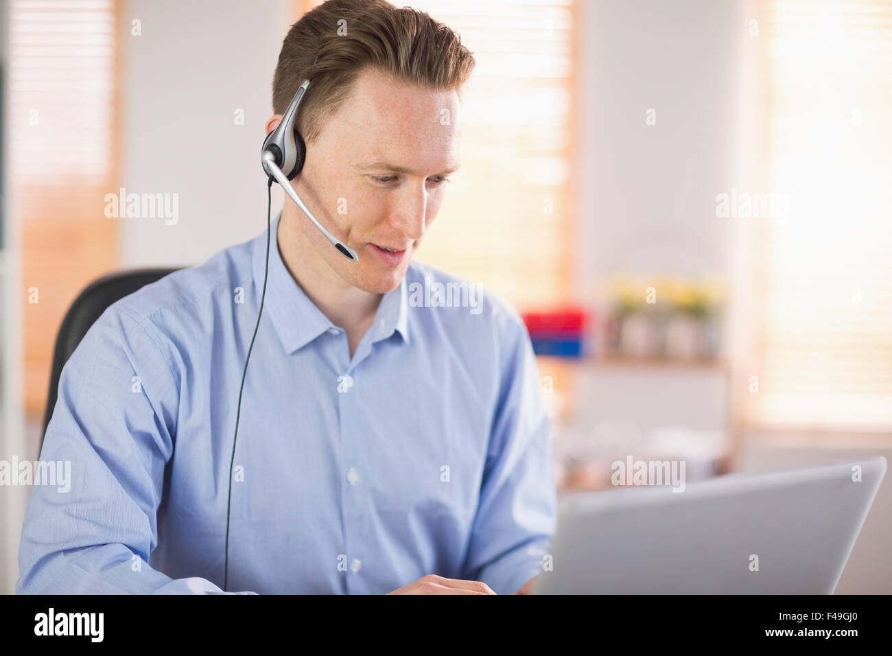 Call center using a headset notebook hi-res stock photography and ...