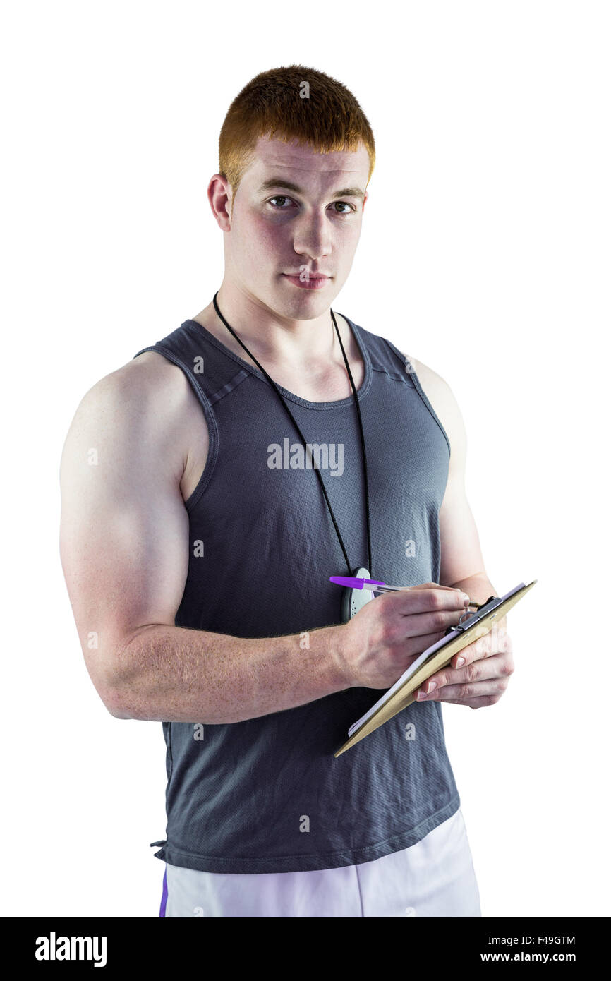Fit personal trainer writing on clipboard Stock Photo - Alamy