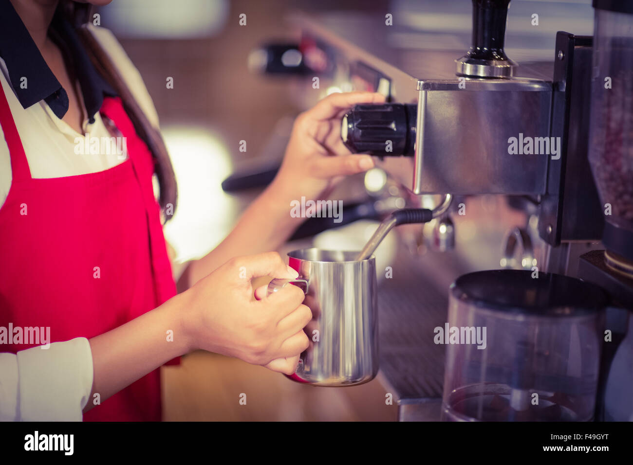 Barista steaming milk at the coffee machine Stock Photo - Alamy