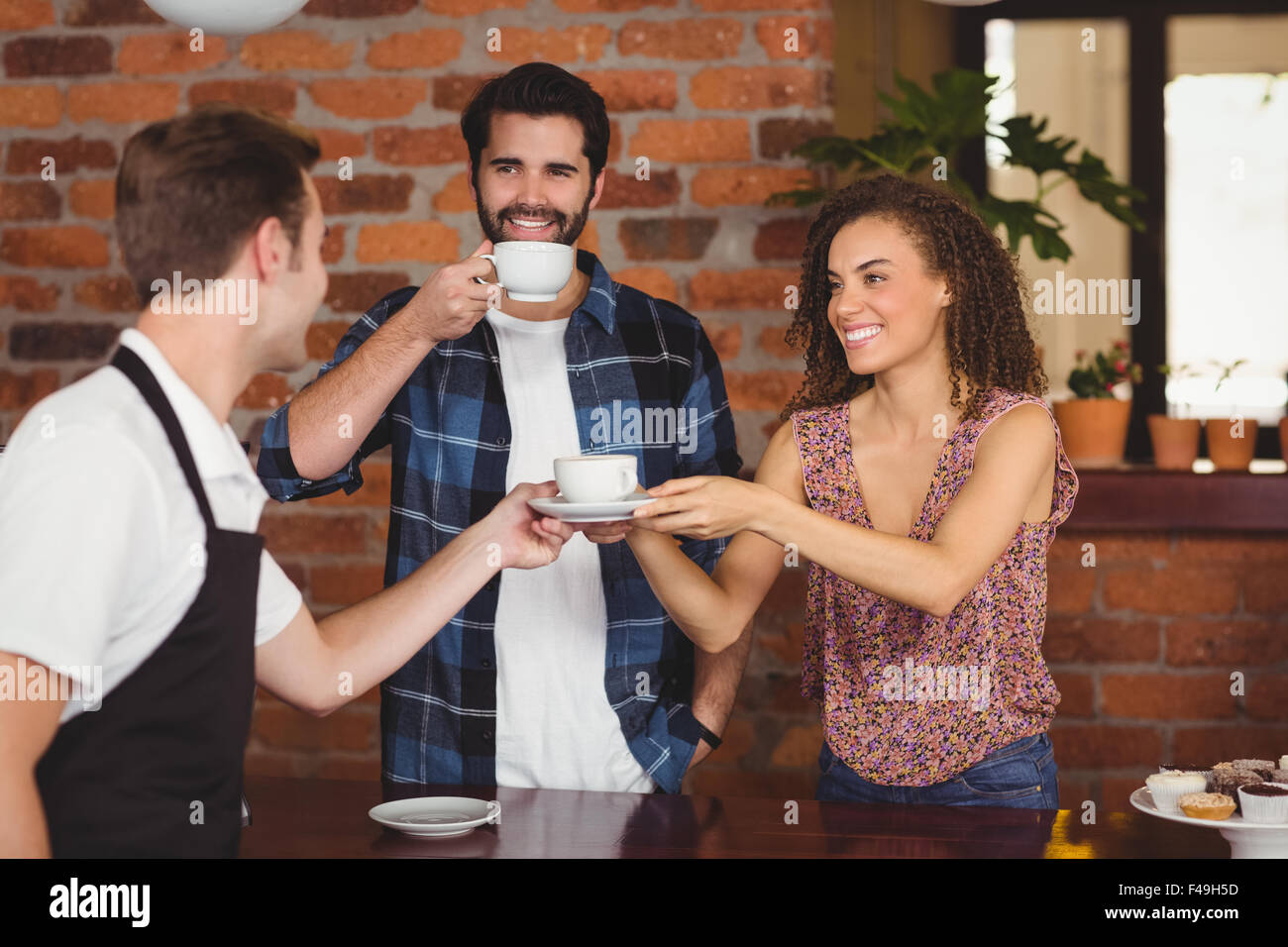Smiling customers getting cup of coffee Stock Photo - Alamy