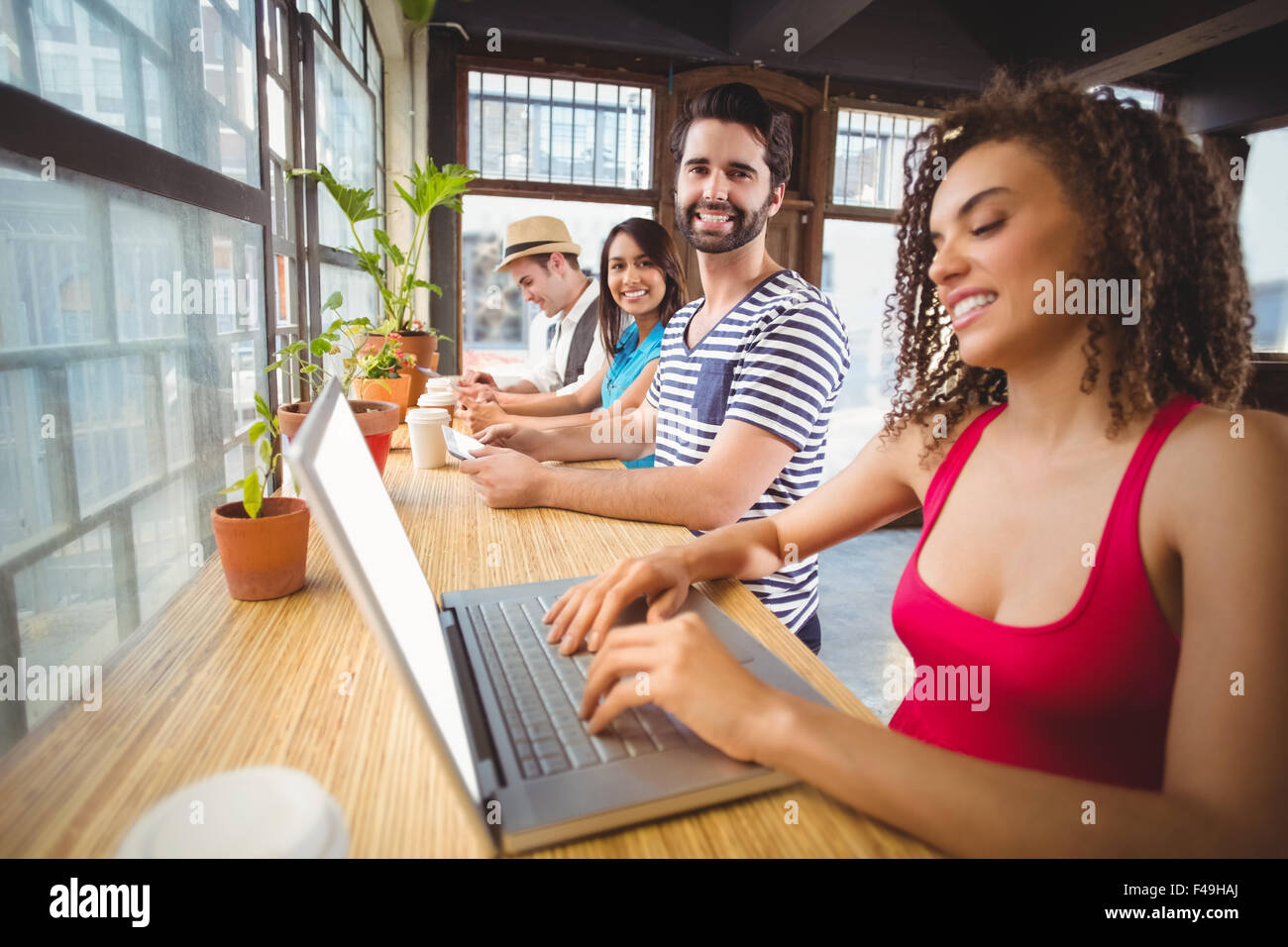 Happy friends using electronic devices Stock Photo - Alamy