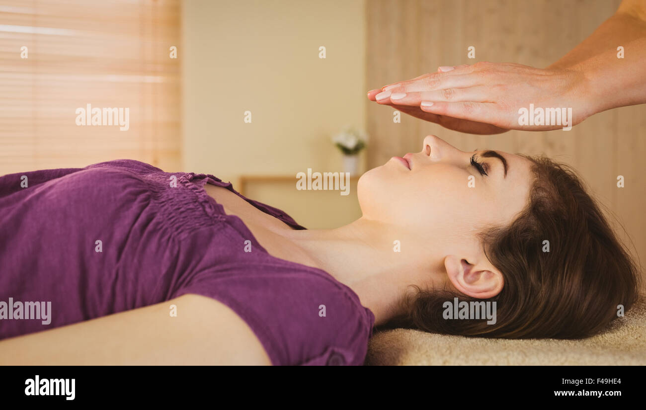 Young woman having a reiki treatment Stock Photo - Alamy