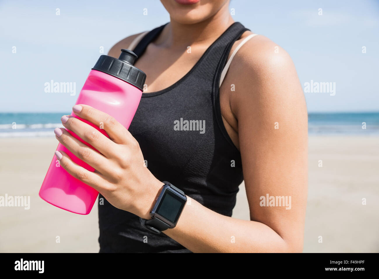 Fit woman wearing smart watch Stock Photo - Alamy