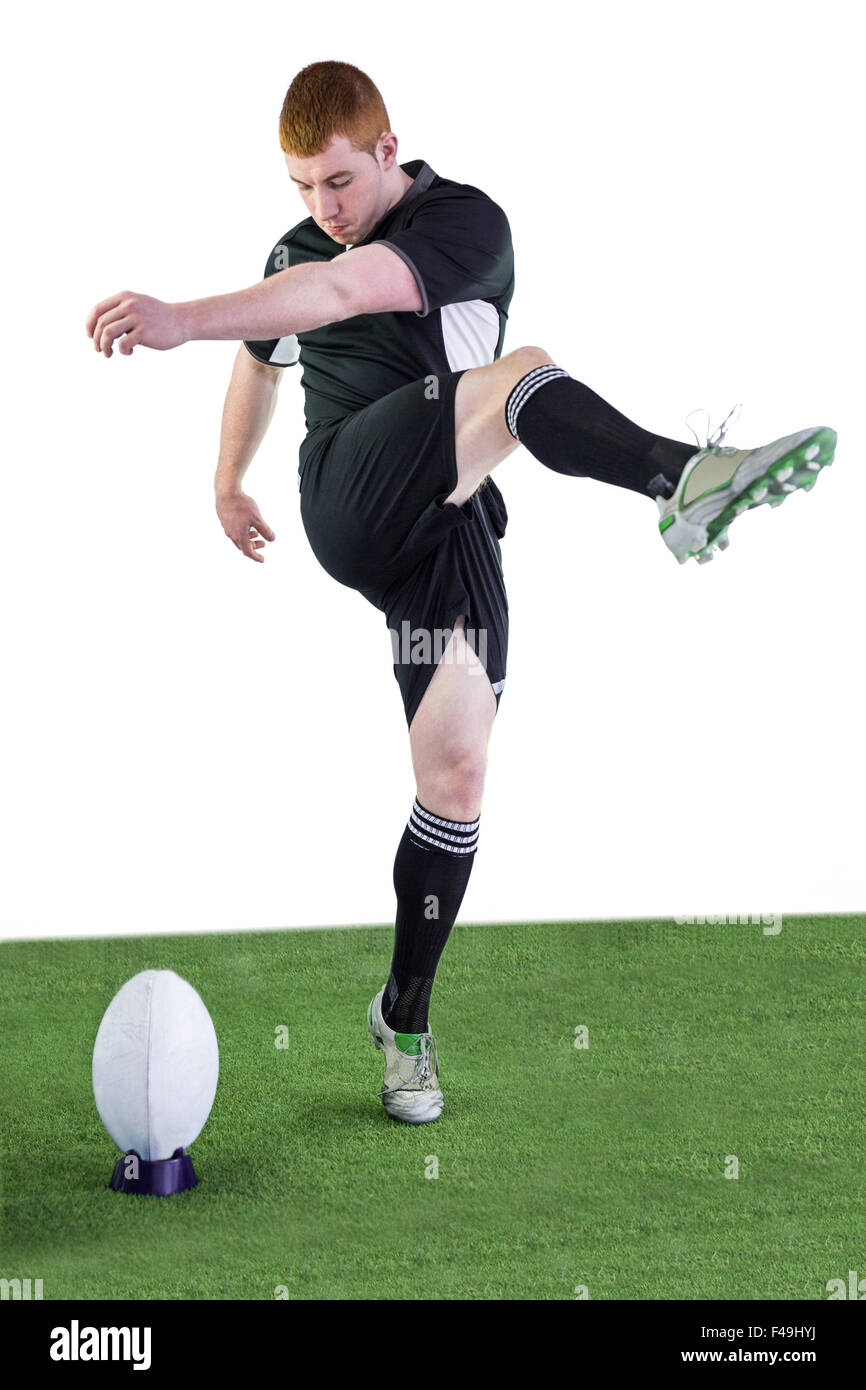 Rugby player doing a drop kick Stock Photo - Alamy