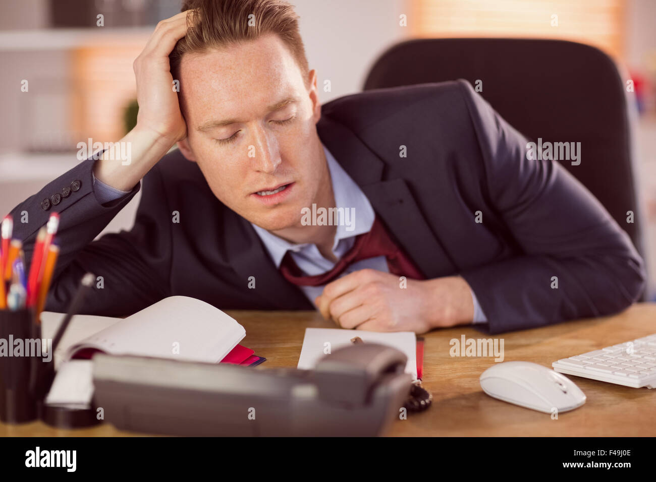Exhausted businessman sleeping at his desk Stock Photo - Alamy
