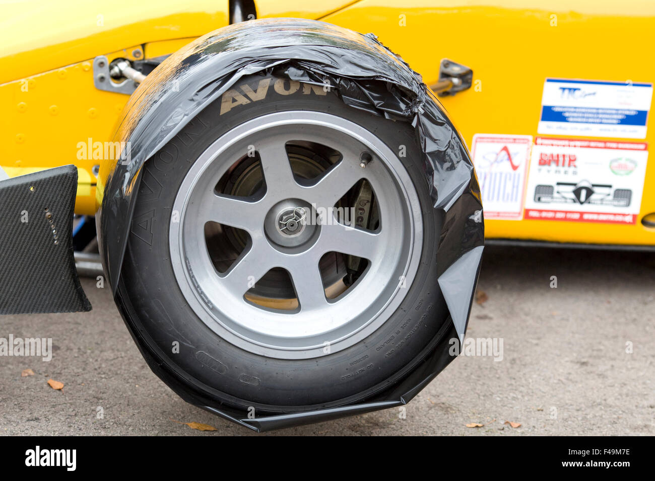 Plastic covering on the tire of a racing car Stock Photo - Alamy