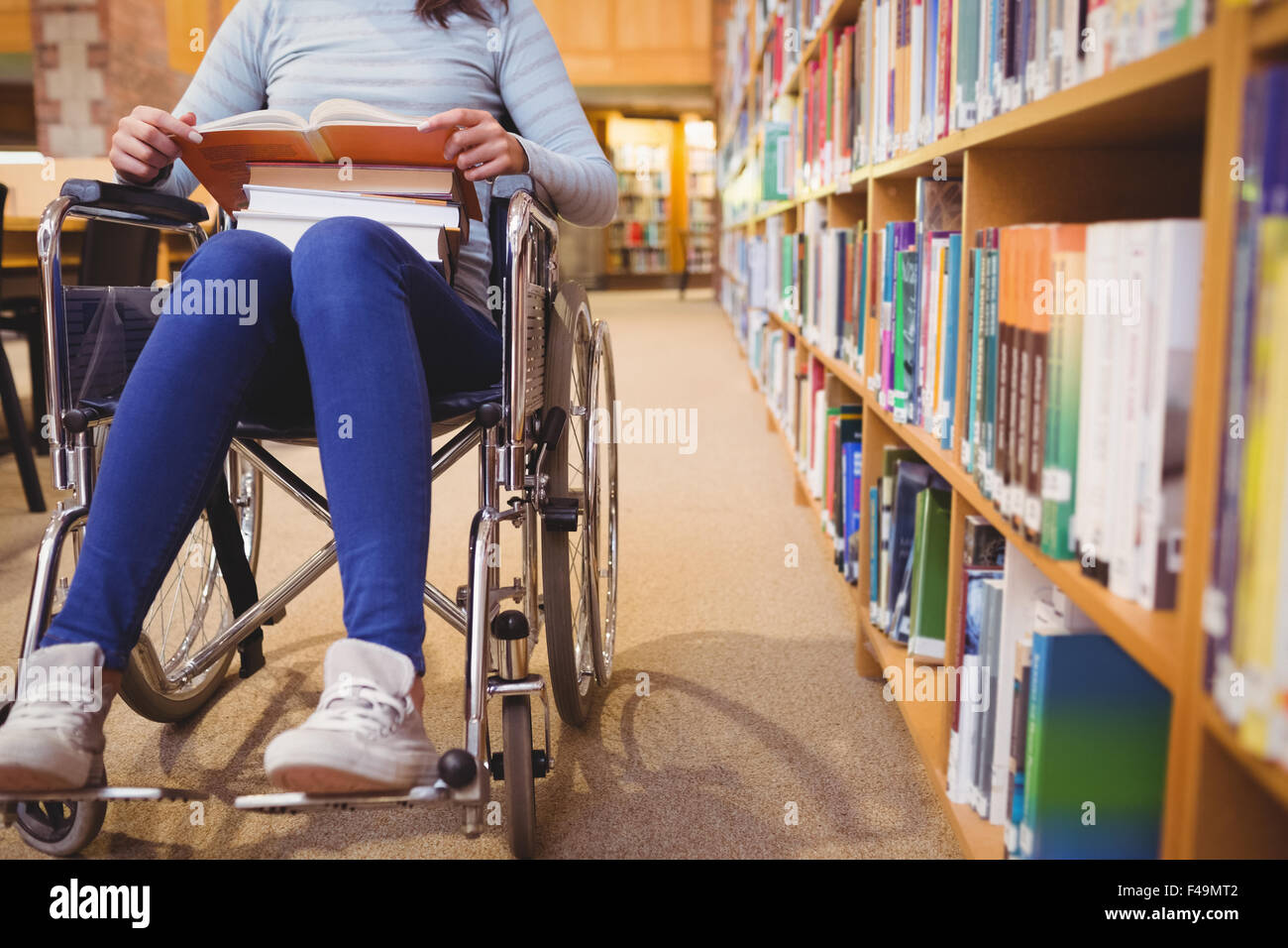 Disabled student reading book Stock Photo - Alamy