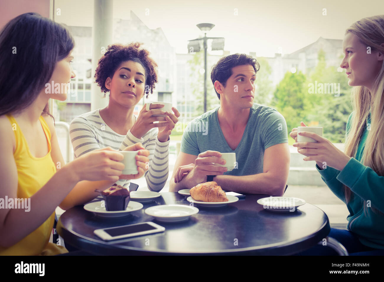 Happy students having coffee together Stock Photo - Alamy