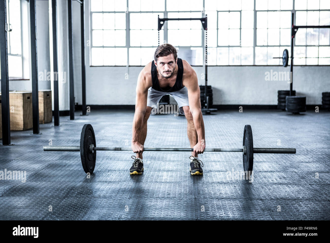 Fit man lifting heavy barbell Stock Photo - Alamy