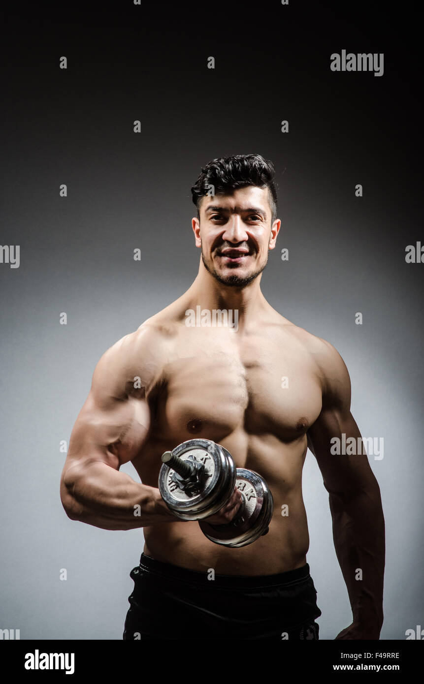 Muscular ripped bodybuilder with dumbbells Stock Photo - Alamy