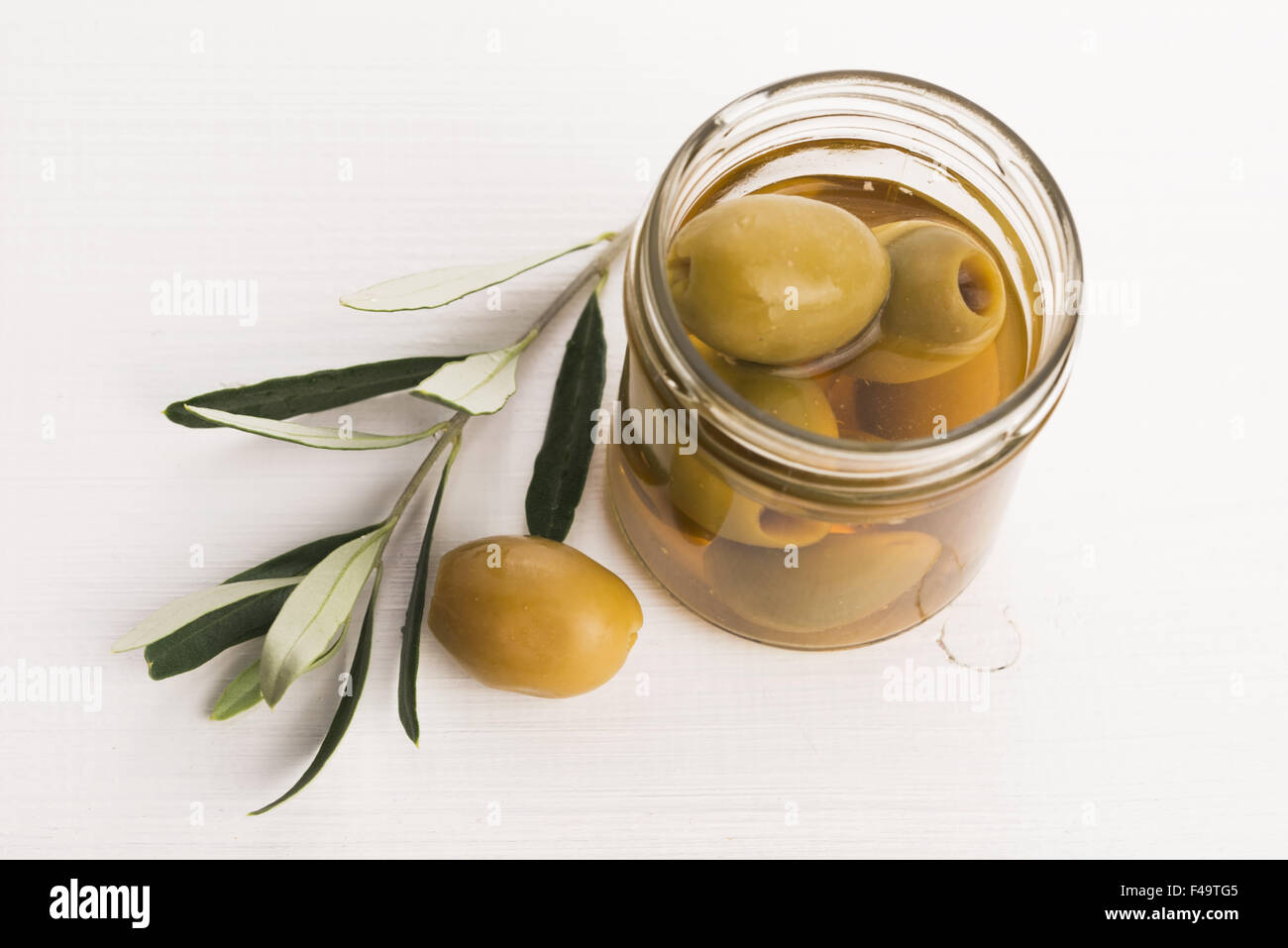 pickled olives and olive tree branch Stock Photo - Alamy