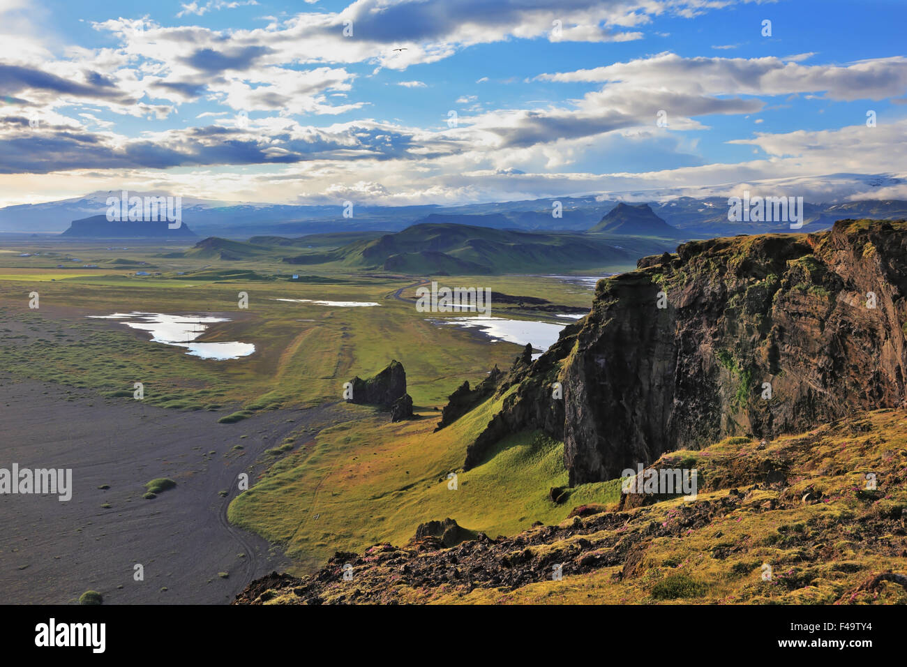 Rock and black coastal sand Stock Photo - Alamy