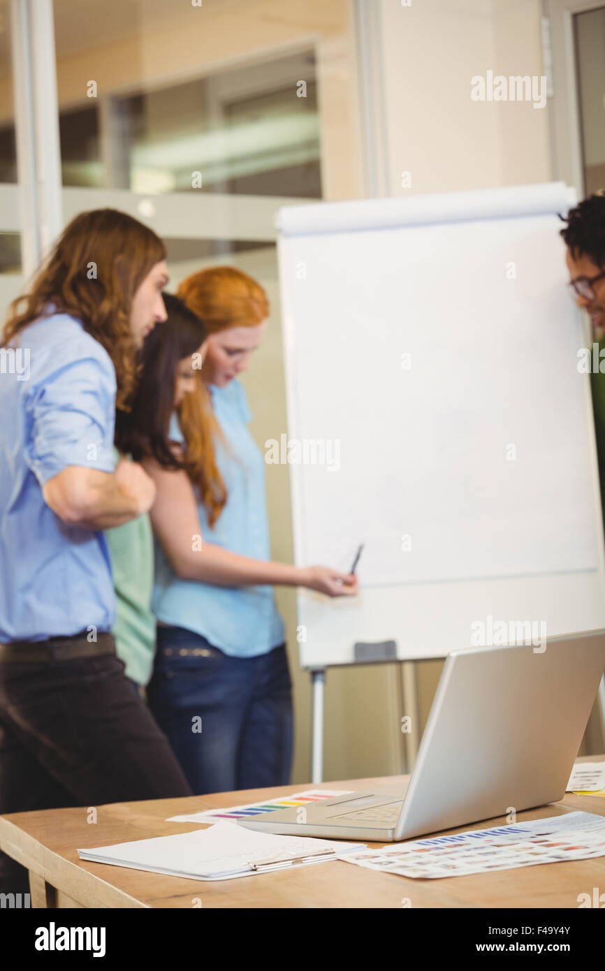 Creative businesswoman explaining colleagues at office Stock Photo - Alamy