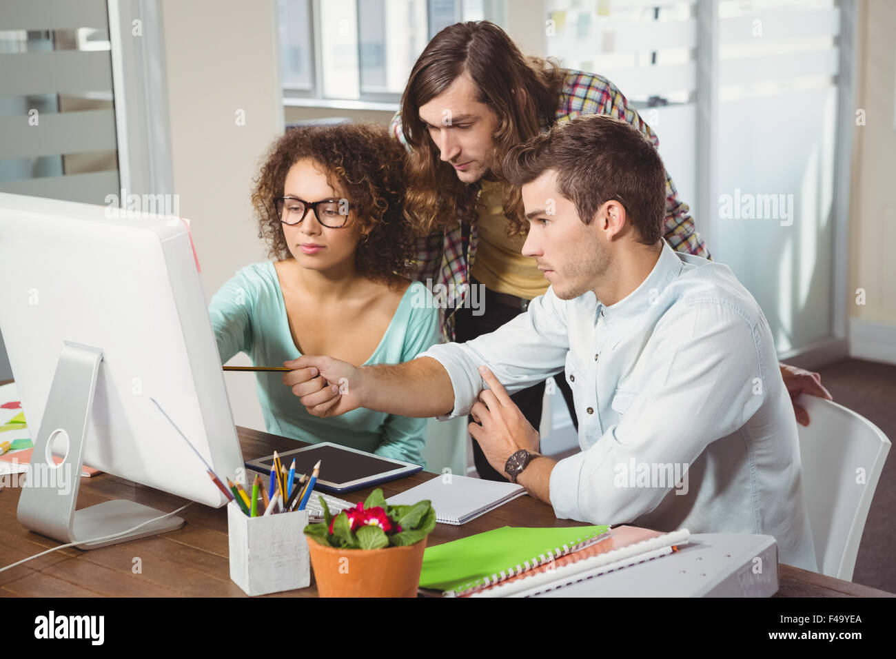 Business people pointing at monitor hi-res stock photography and images ...