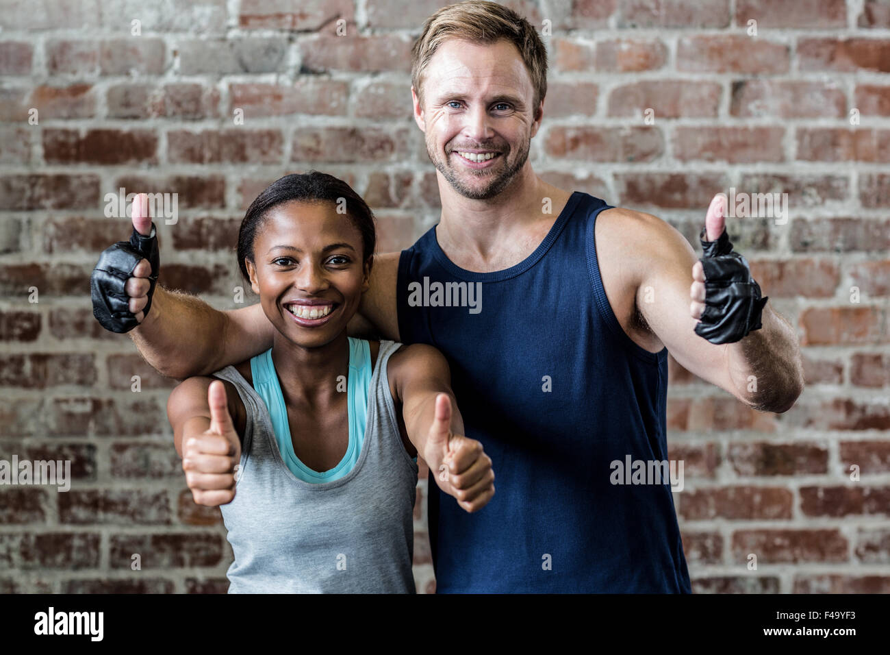 Fit smiling couple posing together Stock Photo - Alamy