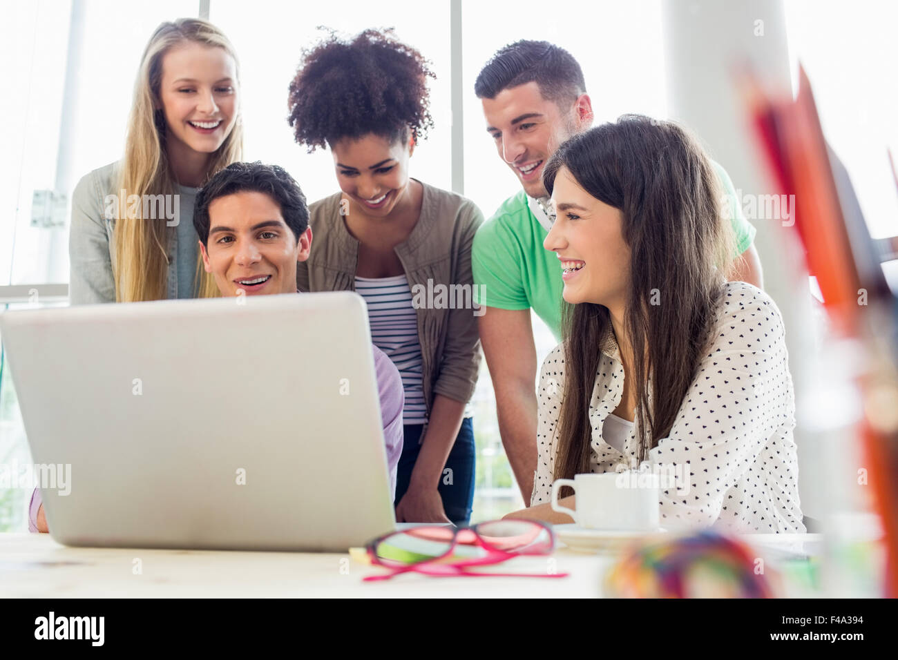 Students working together on laptop Stock Photo - Alamy