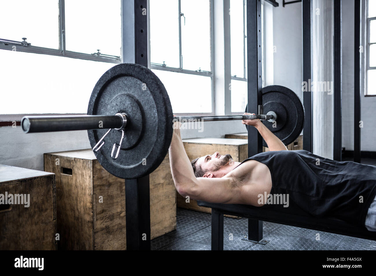 Fit man lifting heavy barbell Stock Photo - Alamy