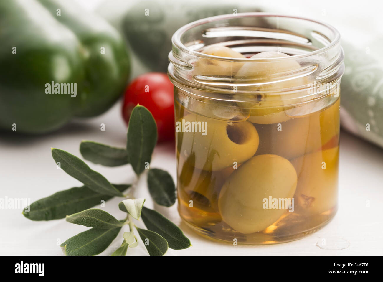 pickled olives and olive tree branch Stock Photo - Alamy