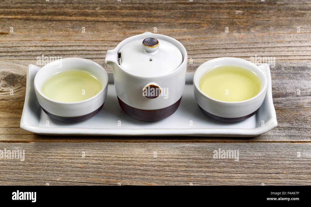 Tea server with ceramic cups, pot and tray on rustic wood Stock Photo ...
