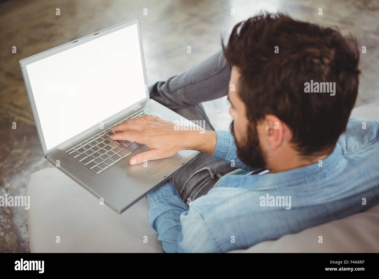 Serious man sitting on couch hi-res stock photography and images - Alamy