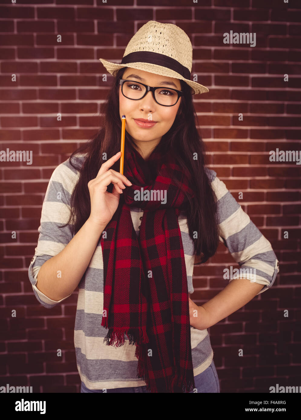 Attractive hipster posing with a pencil Stock Photo - Alamy