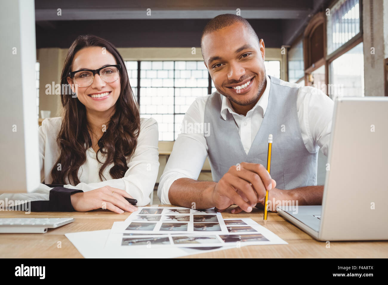 Portrait of smiling people at desk Stock Photo - Alamy