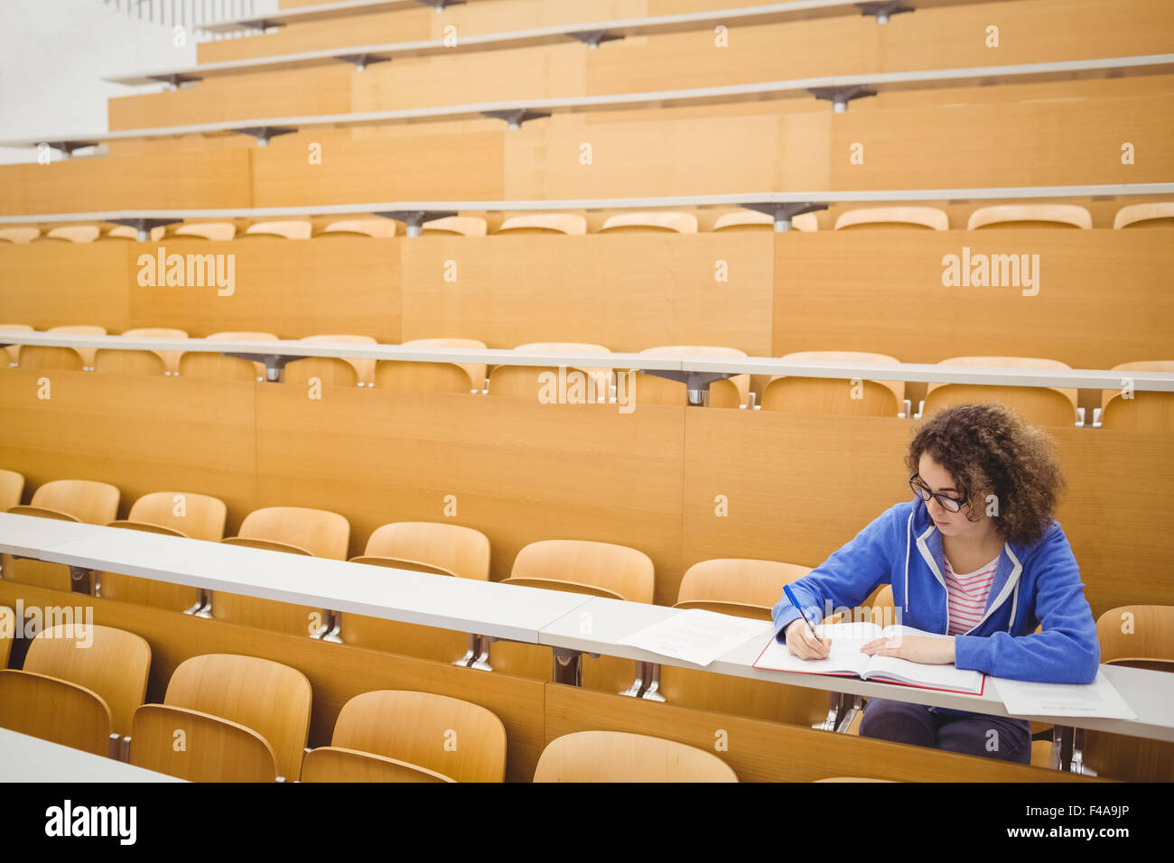 Happy student taking notes in lecture Stock Photo - Alamy