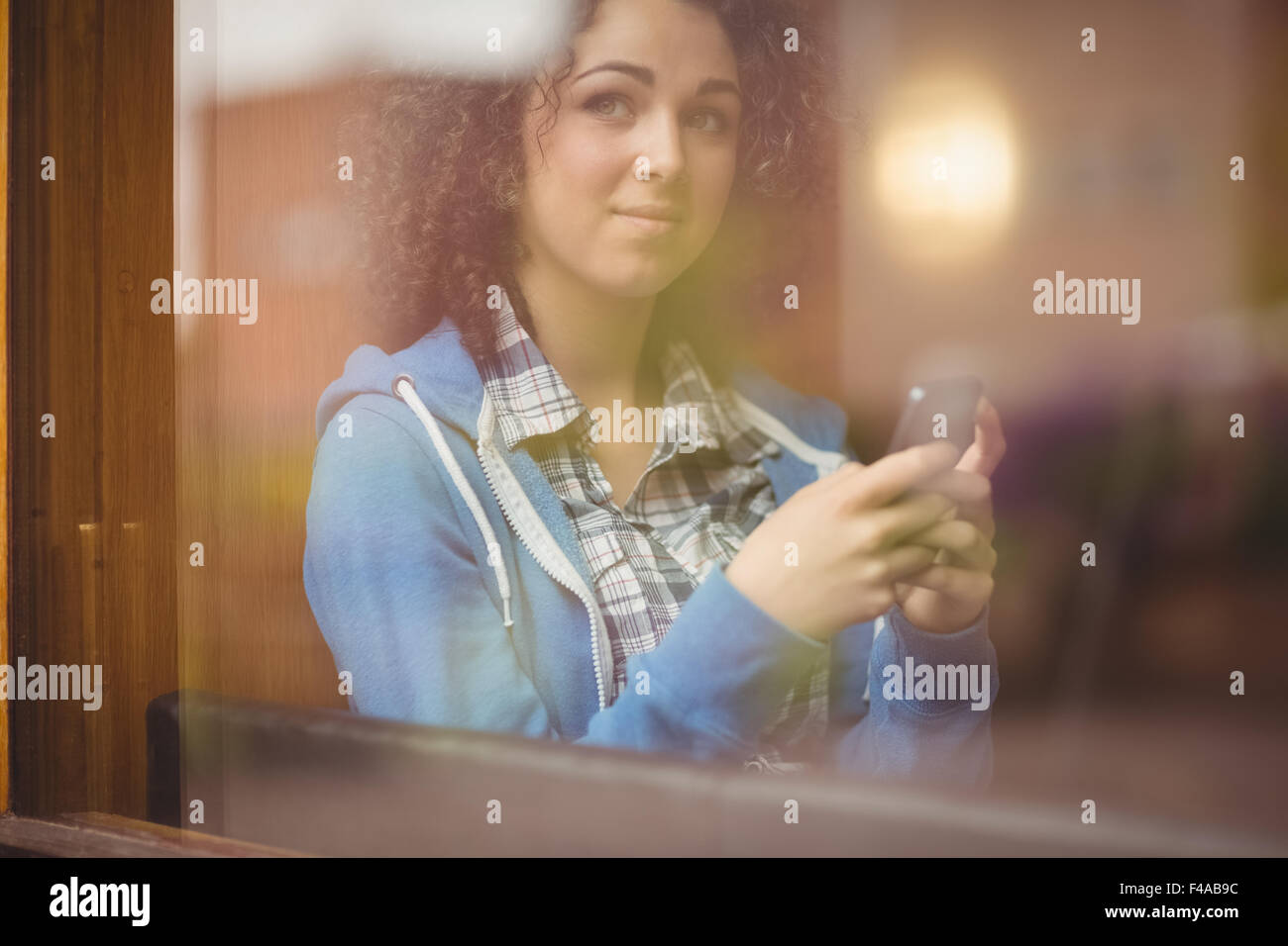 Pretty student sitting by the window having coffee Stock Photo - Alamy