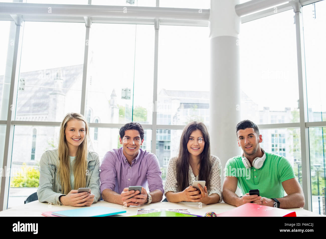 Students smiling at the camera Stock Photo - Alamy