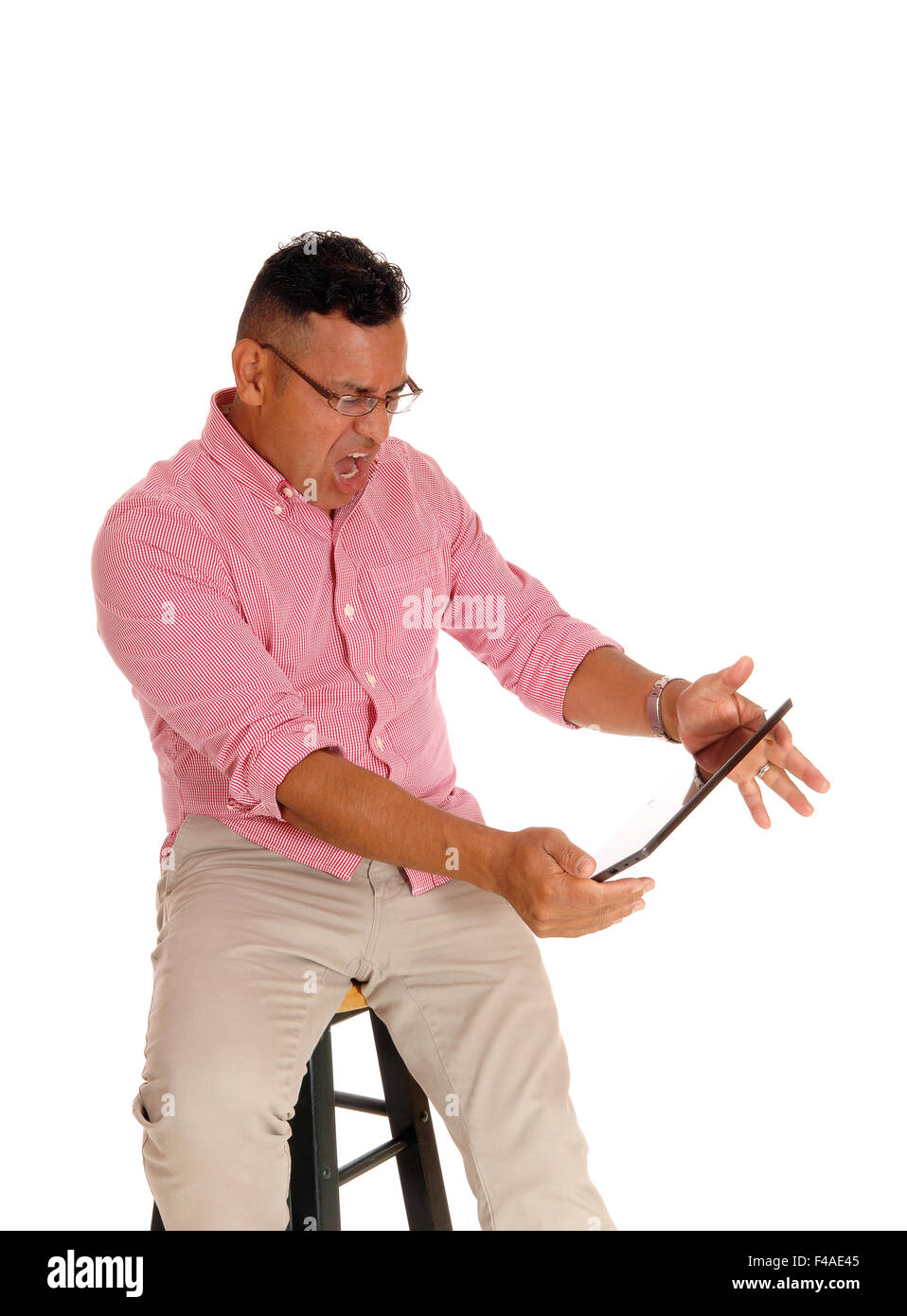 Man screaming at his tablet computer Stock Photo - Alamy
