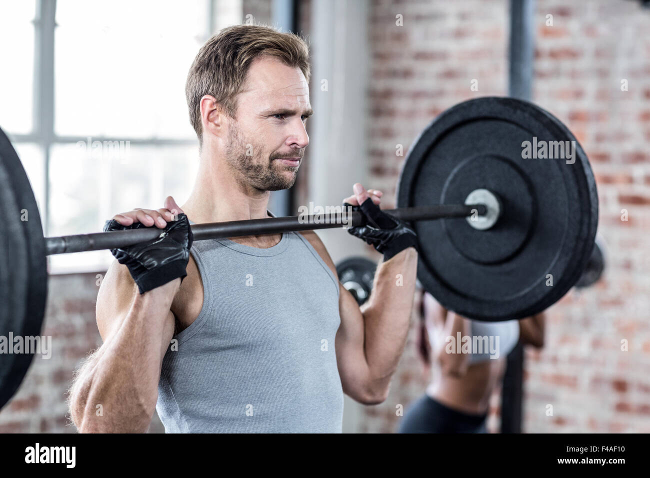 Fit couple lifting weight together Stock Photo - Alamy