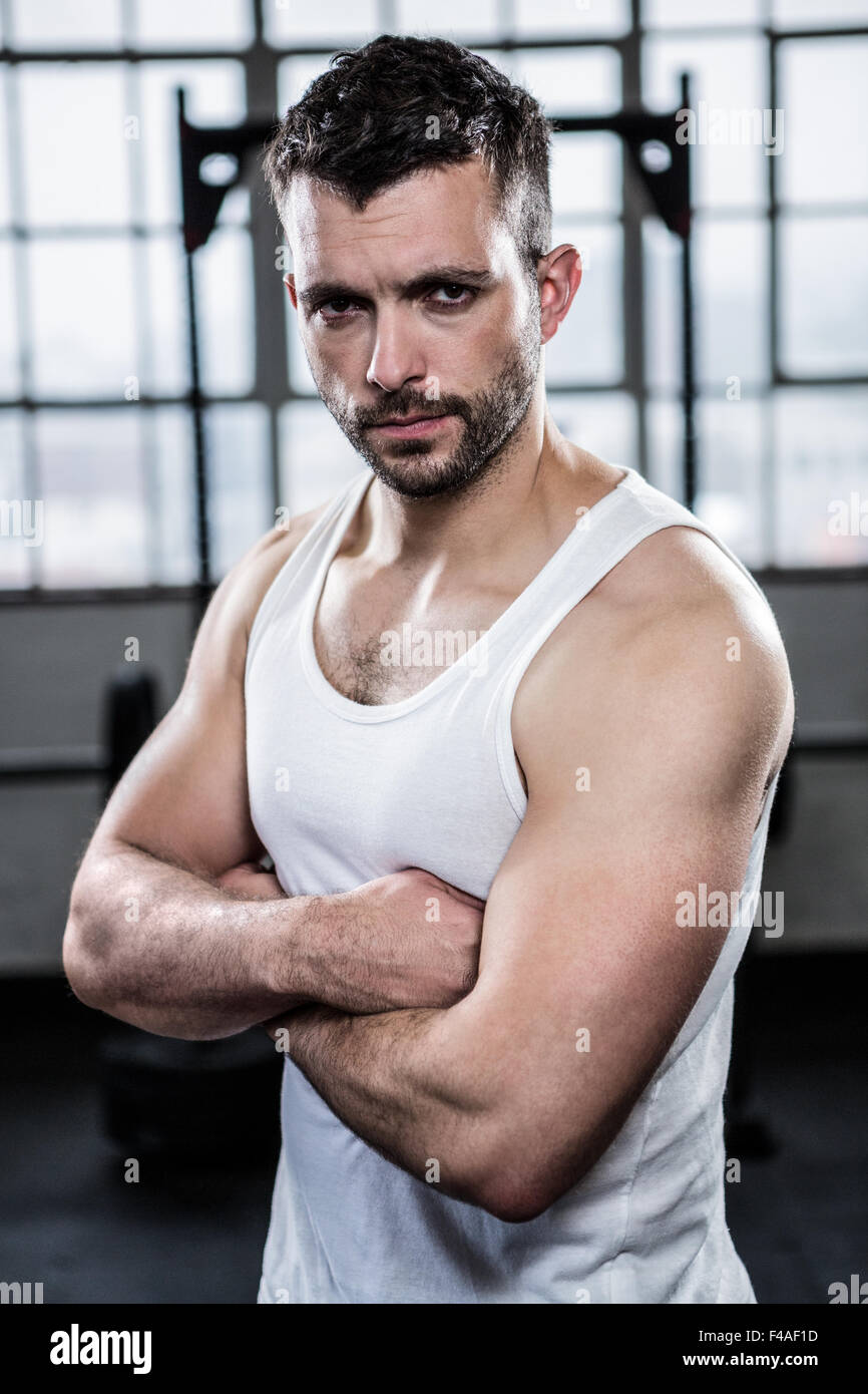 Fit man standing with arms crossed Stock Photo - Alamy