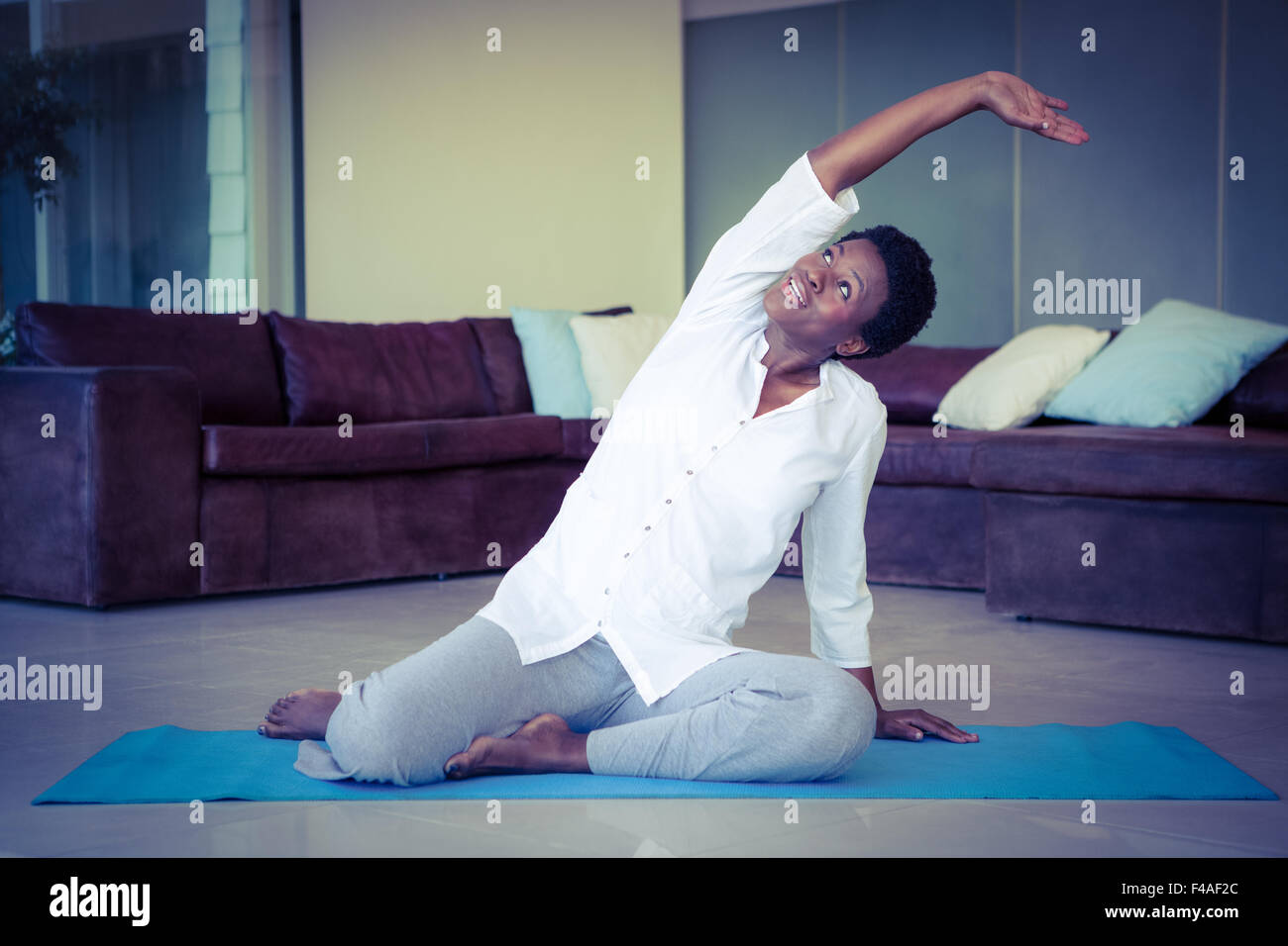 Woman stretching her hand while doing exercise Stock Photo - Alamy