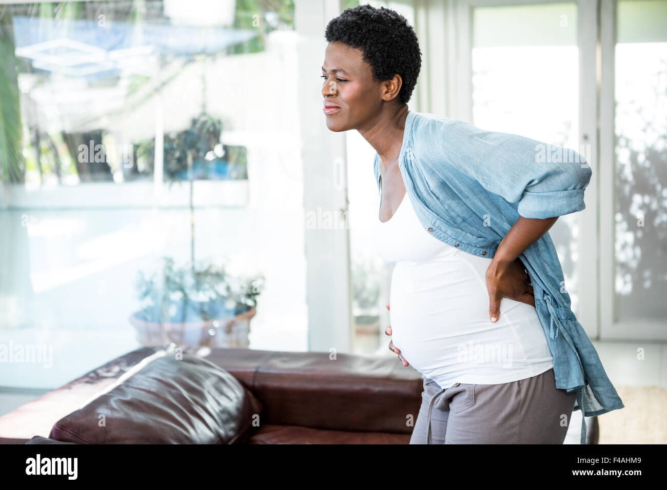 Pregnant woman struggling with a back pain Stock Photo - Alamy