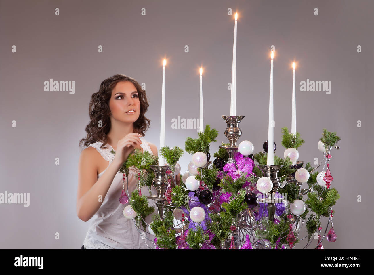 Young Woman Near The Big Candlestick Stock Photo - Alamy