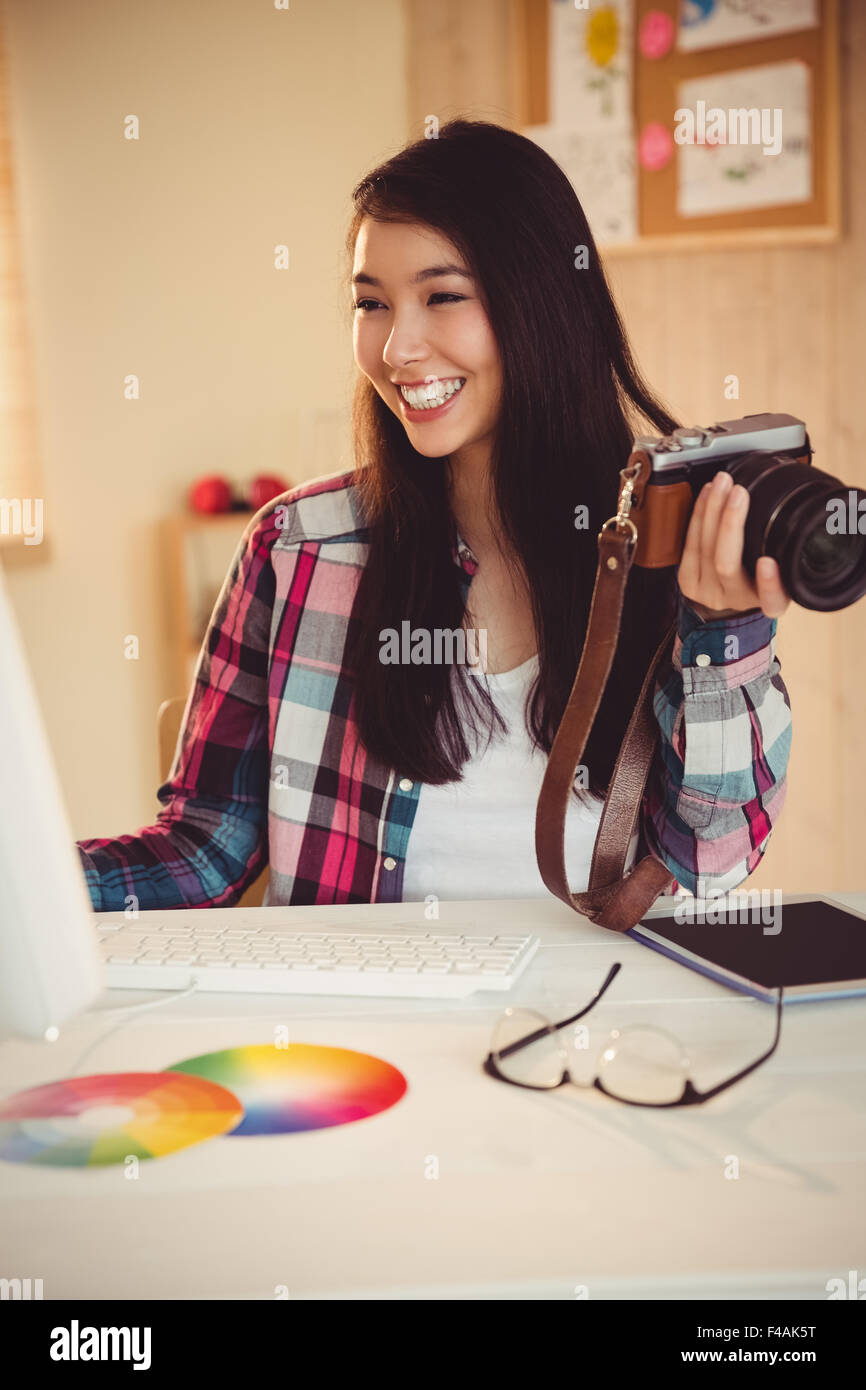 Happy photographer holding her camera Stock Photo - Alamy