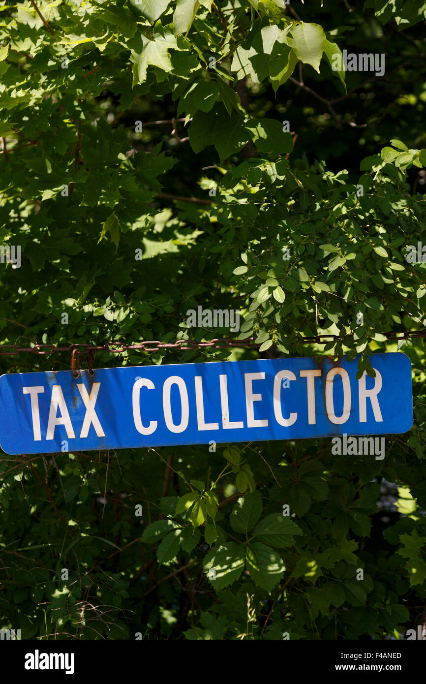 Tax Collector sign white letters blue background on a hedge Stock Photo ...