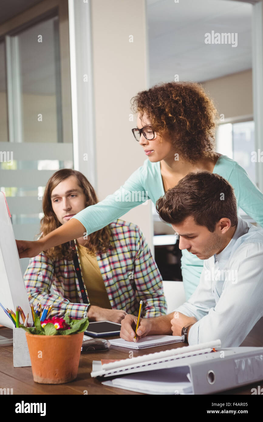 Businesswoman pointing at computer screen Stock Photo - Alamy