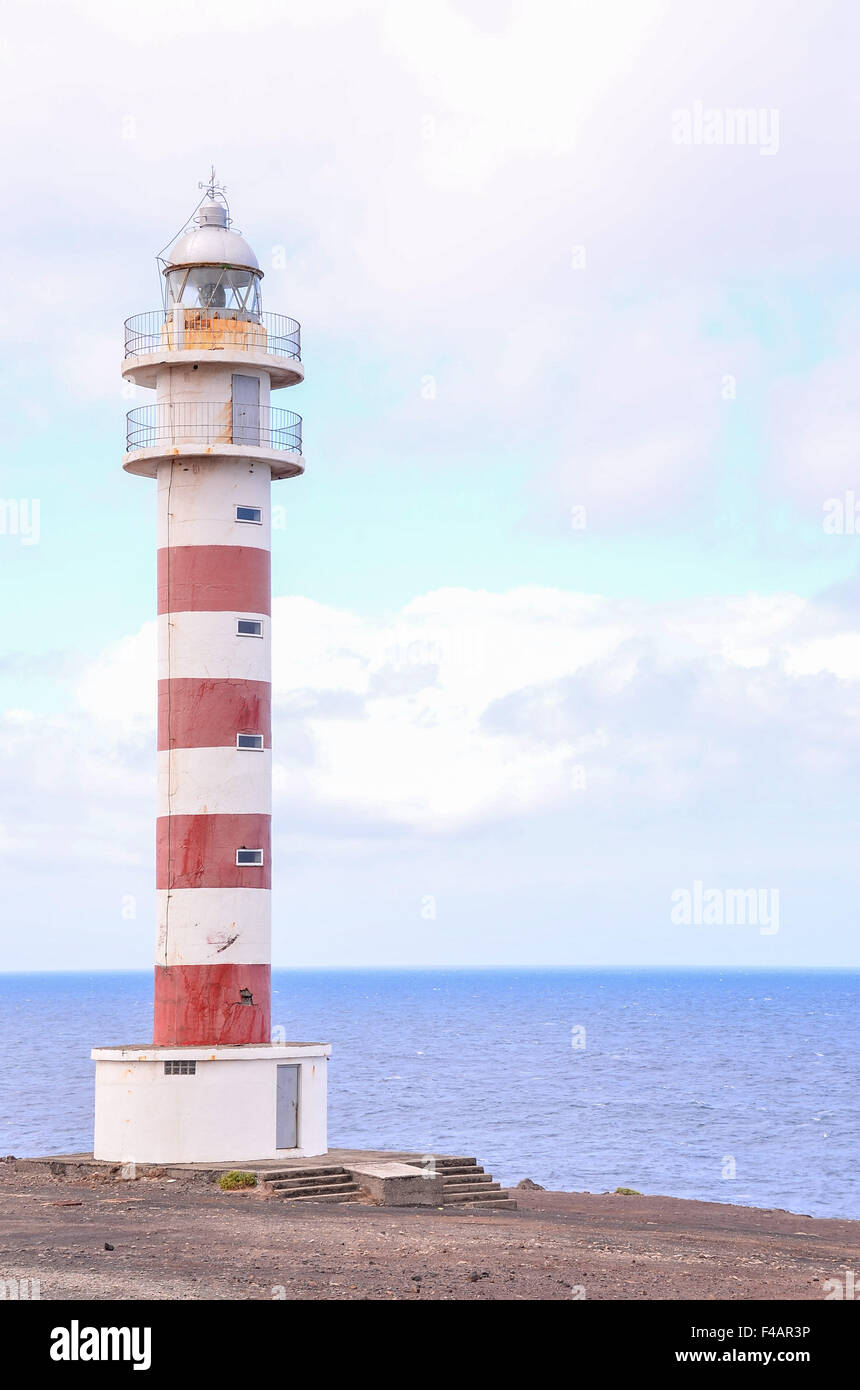 High Lighthouse near the Coast Stock Photo - Alamy