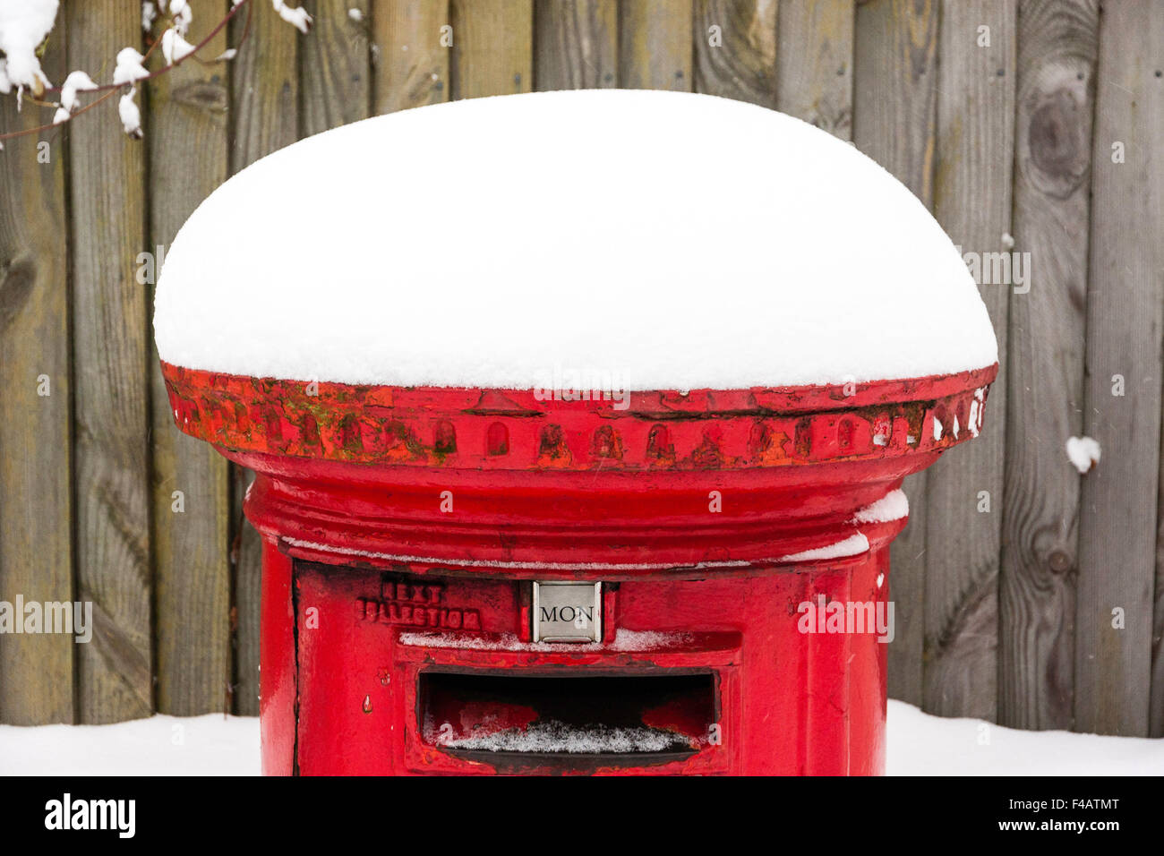 England. Red English Post box, (letter box, pillar box), covered in ...