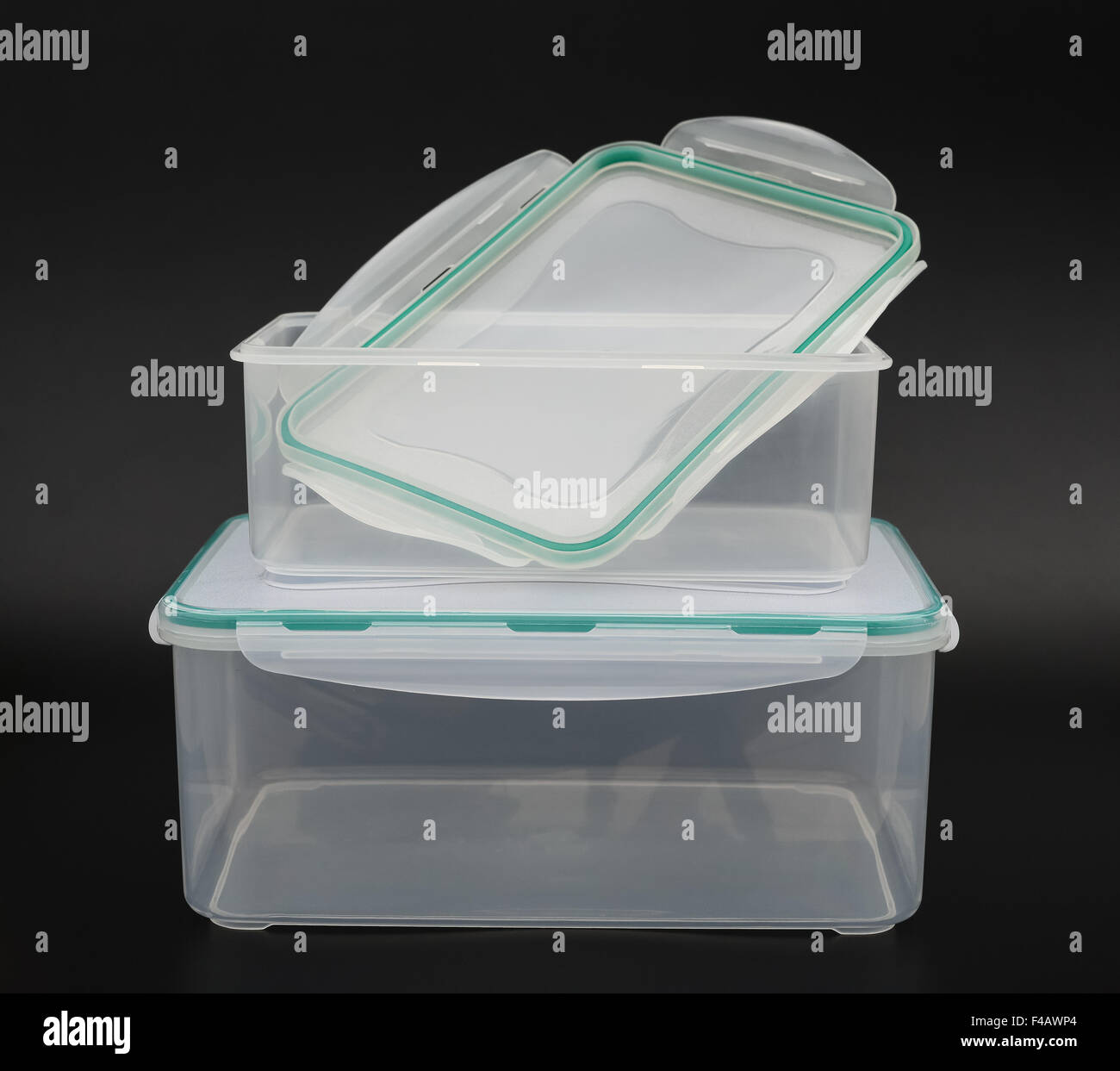 translucent storage boxes with one opened on a black background Stock ...