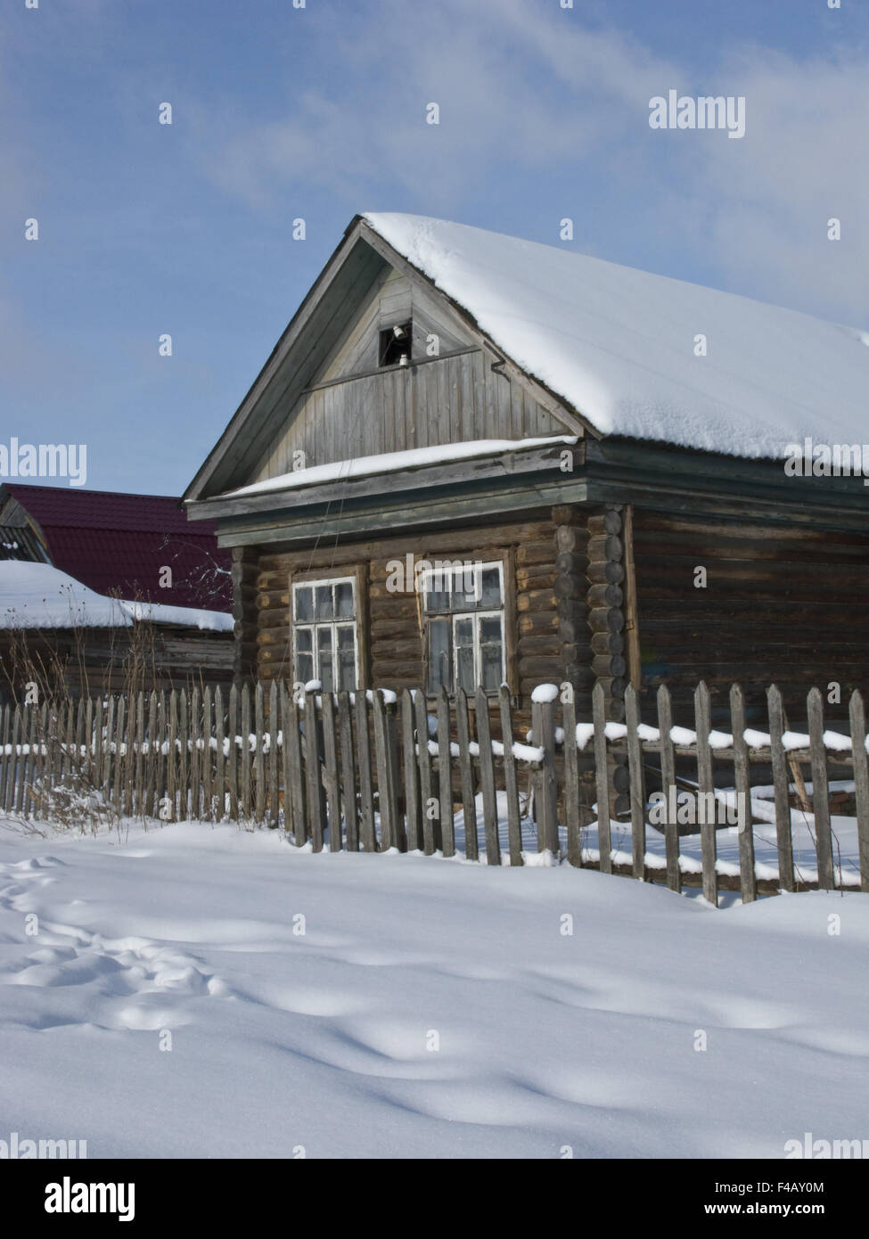 Snow covered wooden house in russian village Stock Photo - Alamy