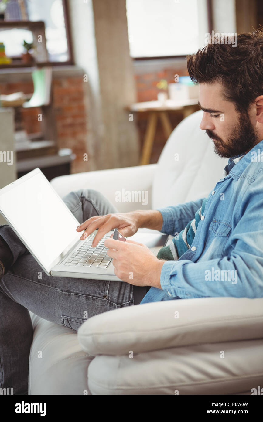 Side view of man using laptop Stock Photo - Alamy