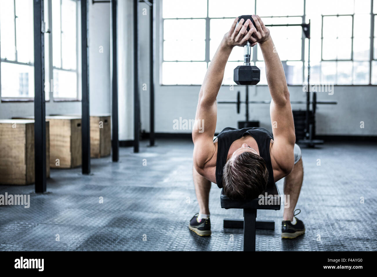 Fit man lifting heavy black dumbbell Stock Photo - Alamy