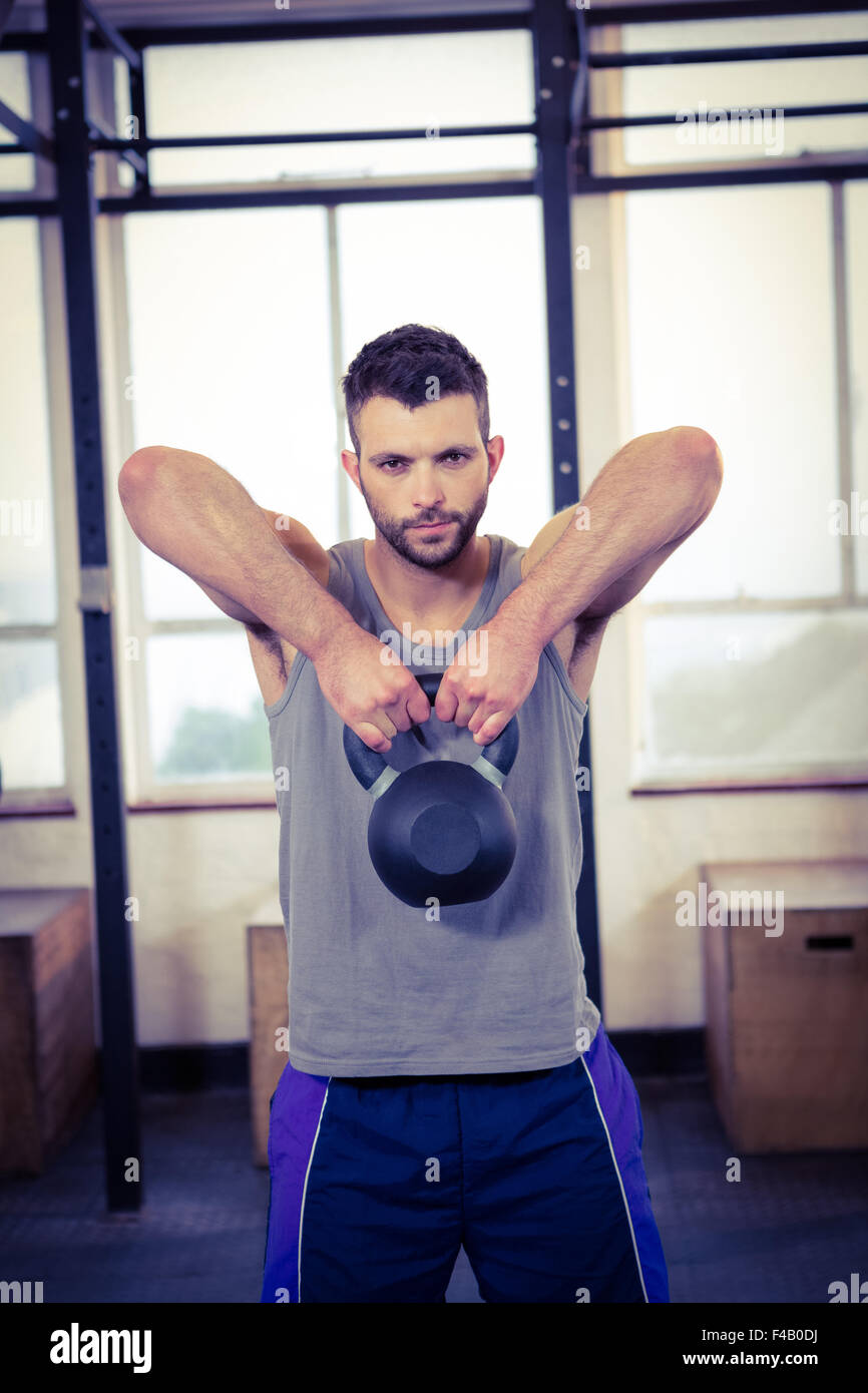 Fit man working out with kettlebell Stock Photo - Alamy
