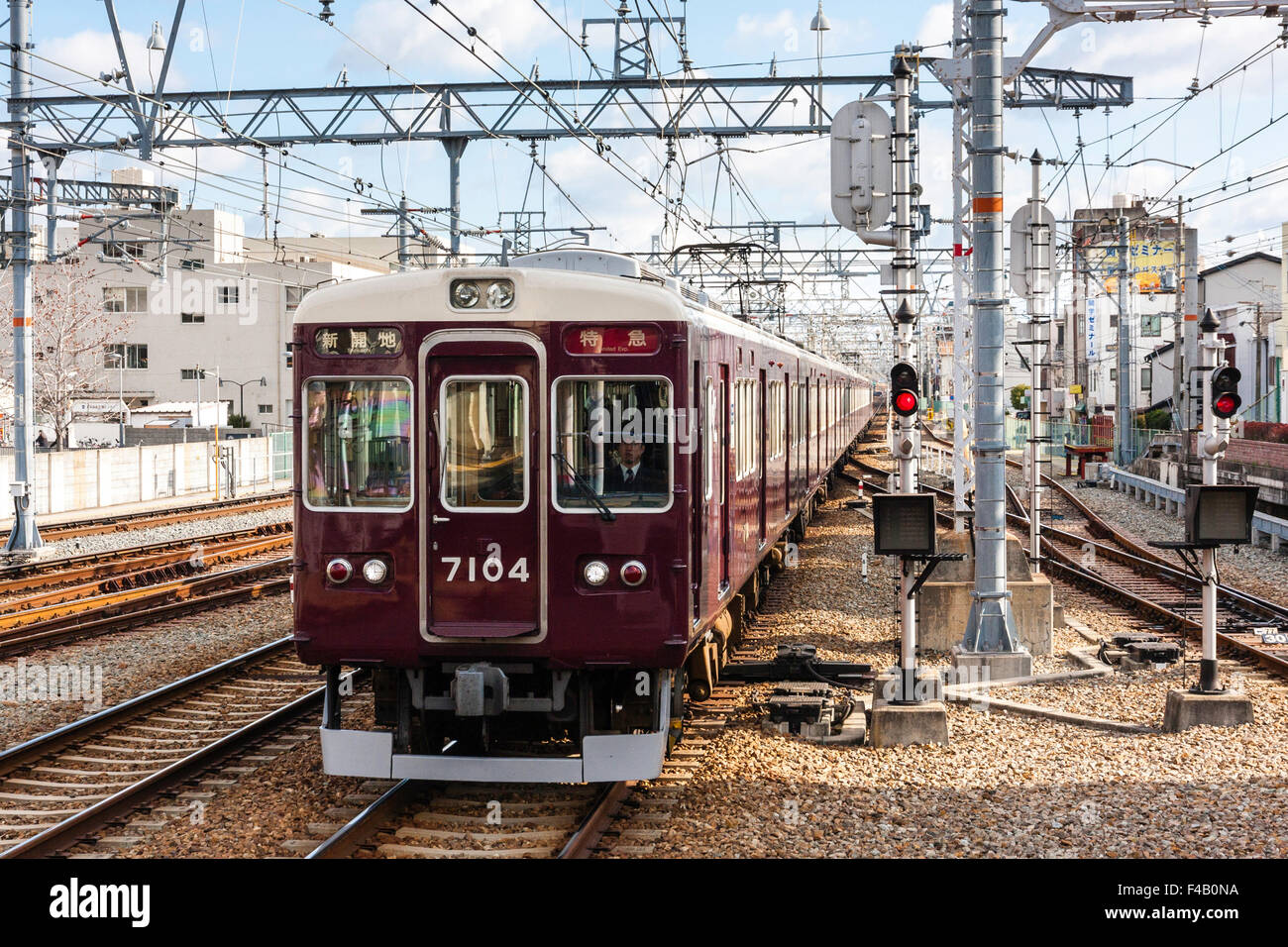Japan, Hankyu private railway. Express maroon train arriving at ...