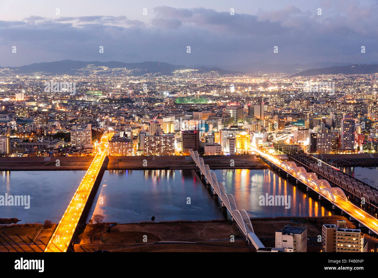 Japan, Osaka, view from Umeda Sky Building, night time. Juso Bridge ...