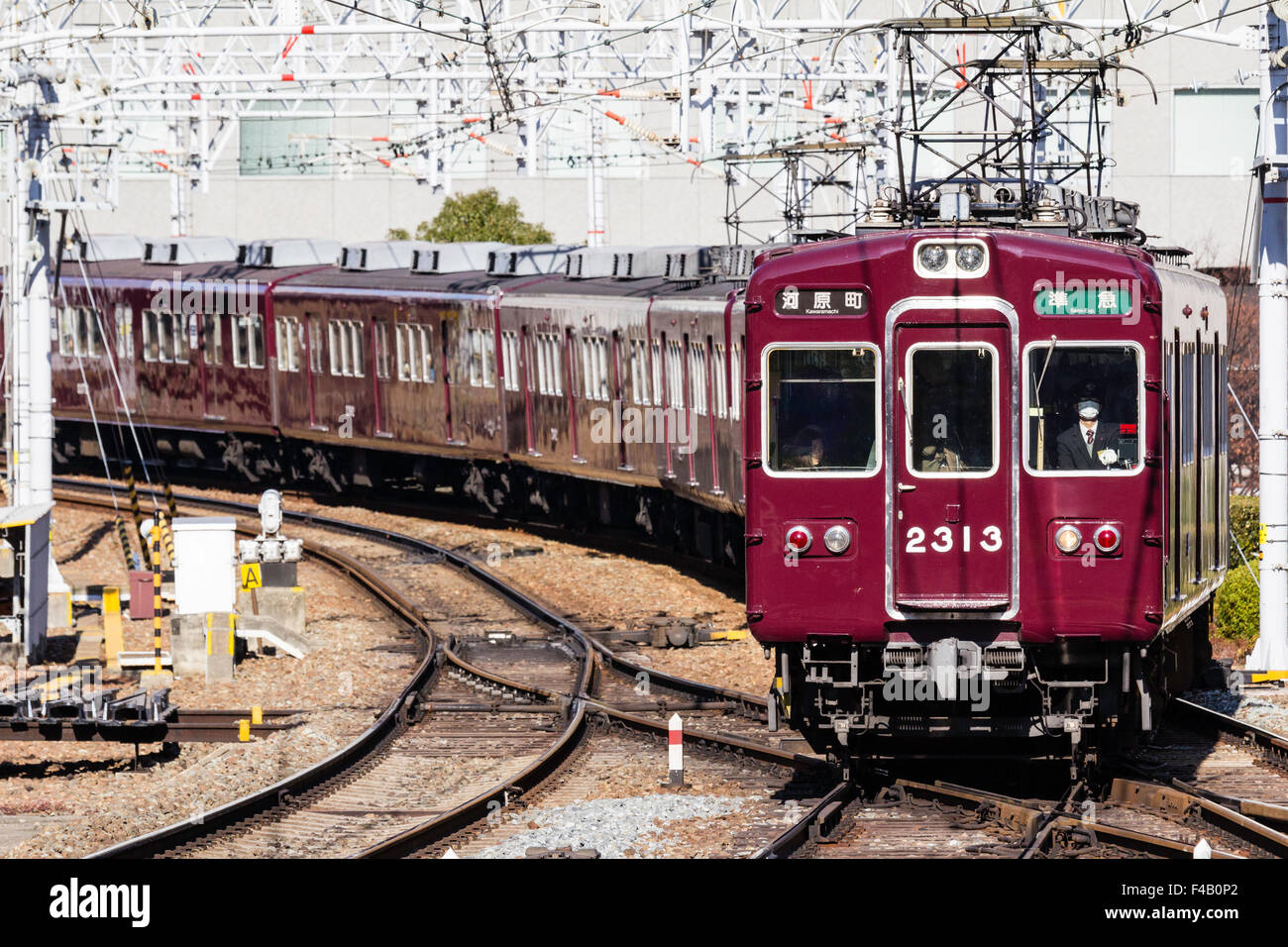 Japan, Osaka, Umeda. Private Hankyu railway, Maroon coloured semi ...